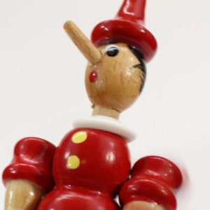 The Classic Pinocchio Thumb Activated Push Button Toy, Figurine With ...