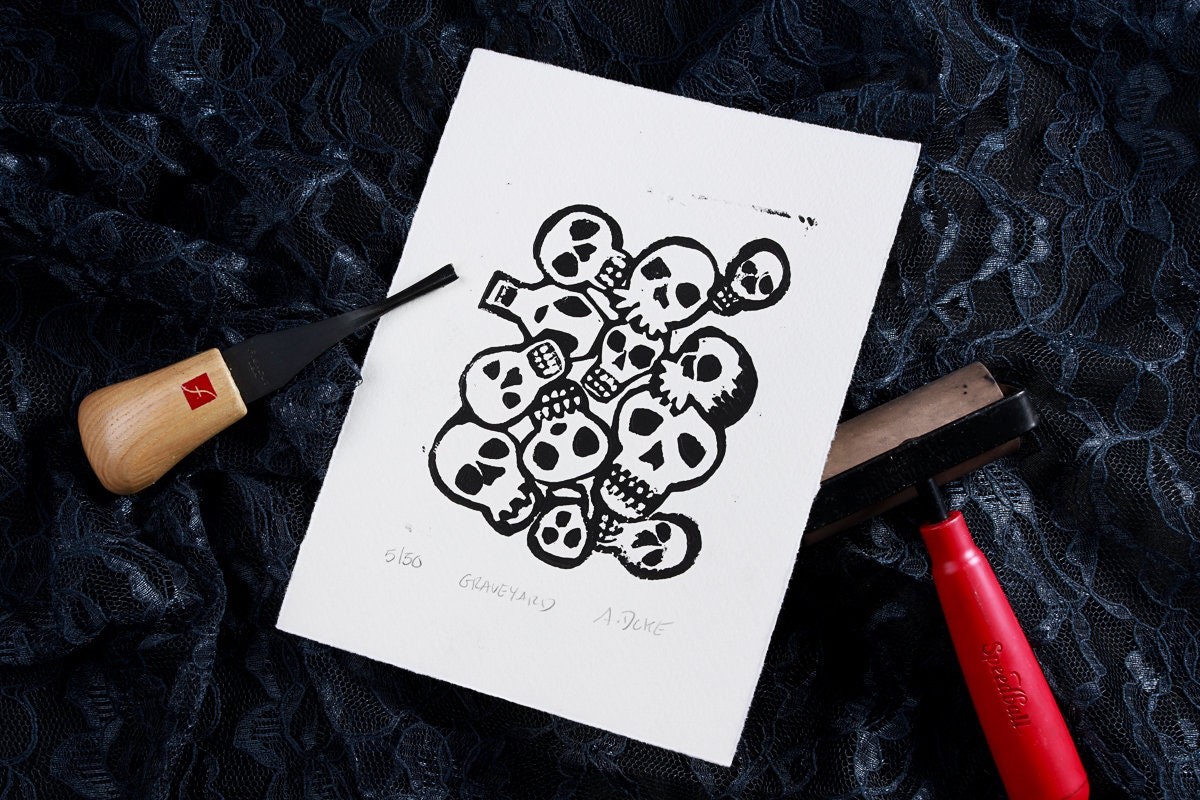 Graveyard Linocut Print pile of Skulls - Etsy