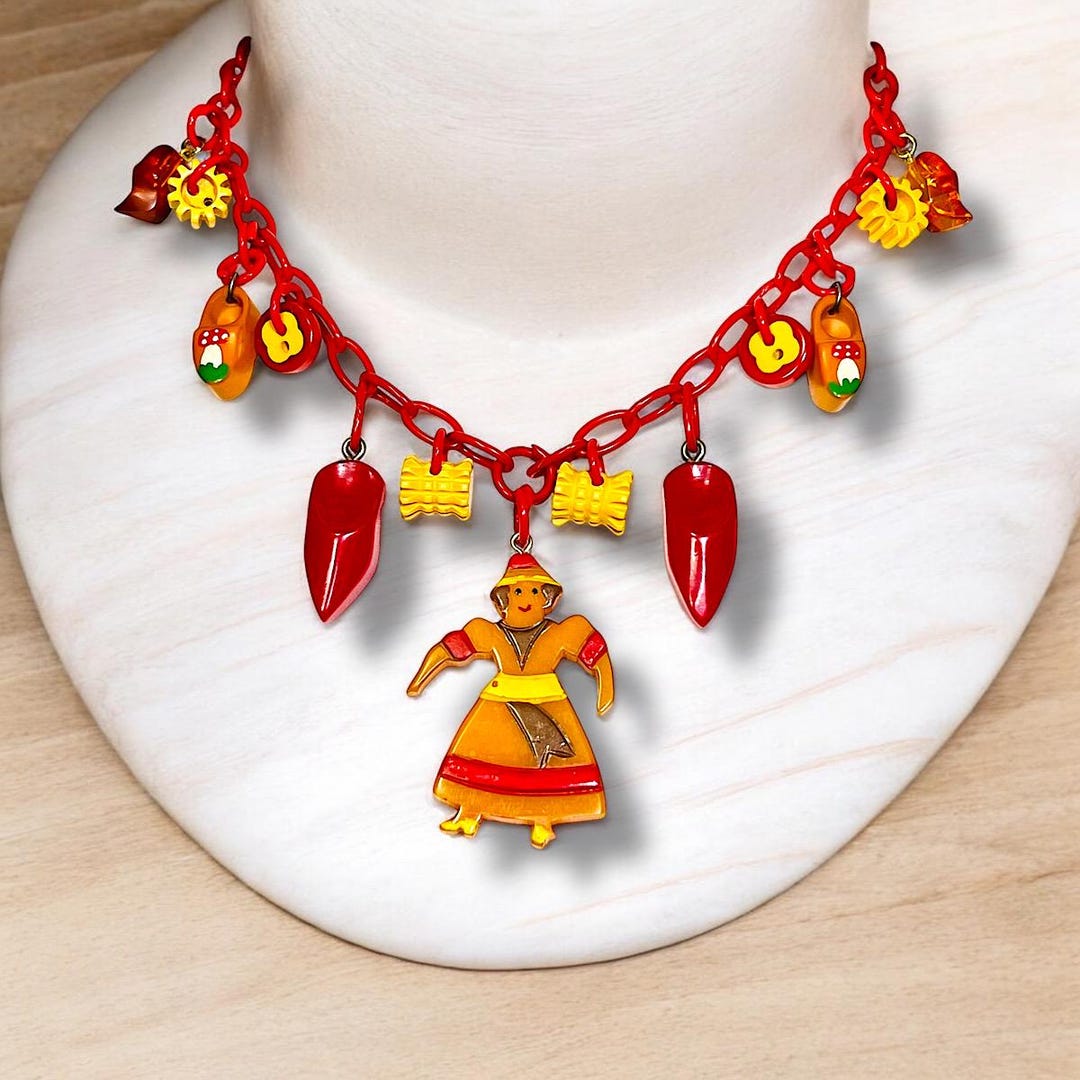 Vintages Carved Bakelite Dutch Girl and Shoes Charm Necklace on Red ...