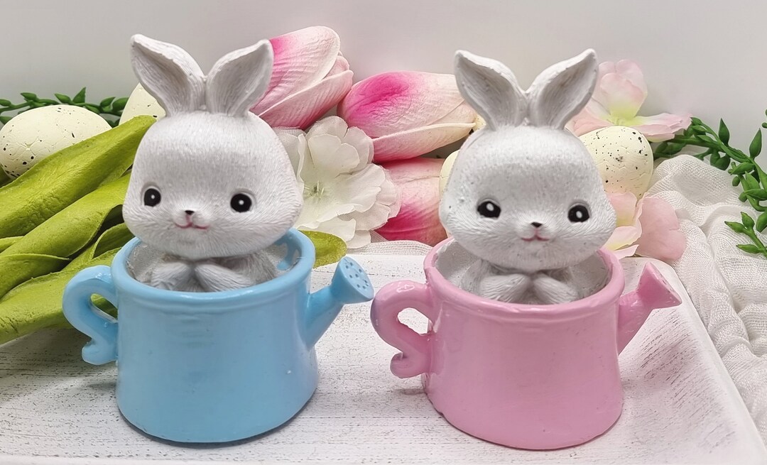Easter Bunny Boy and Bunny Girl Figures Are Sitting in a Small Watering ...