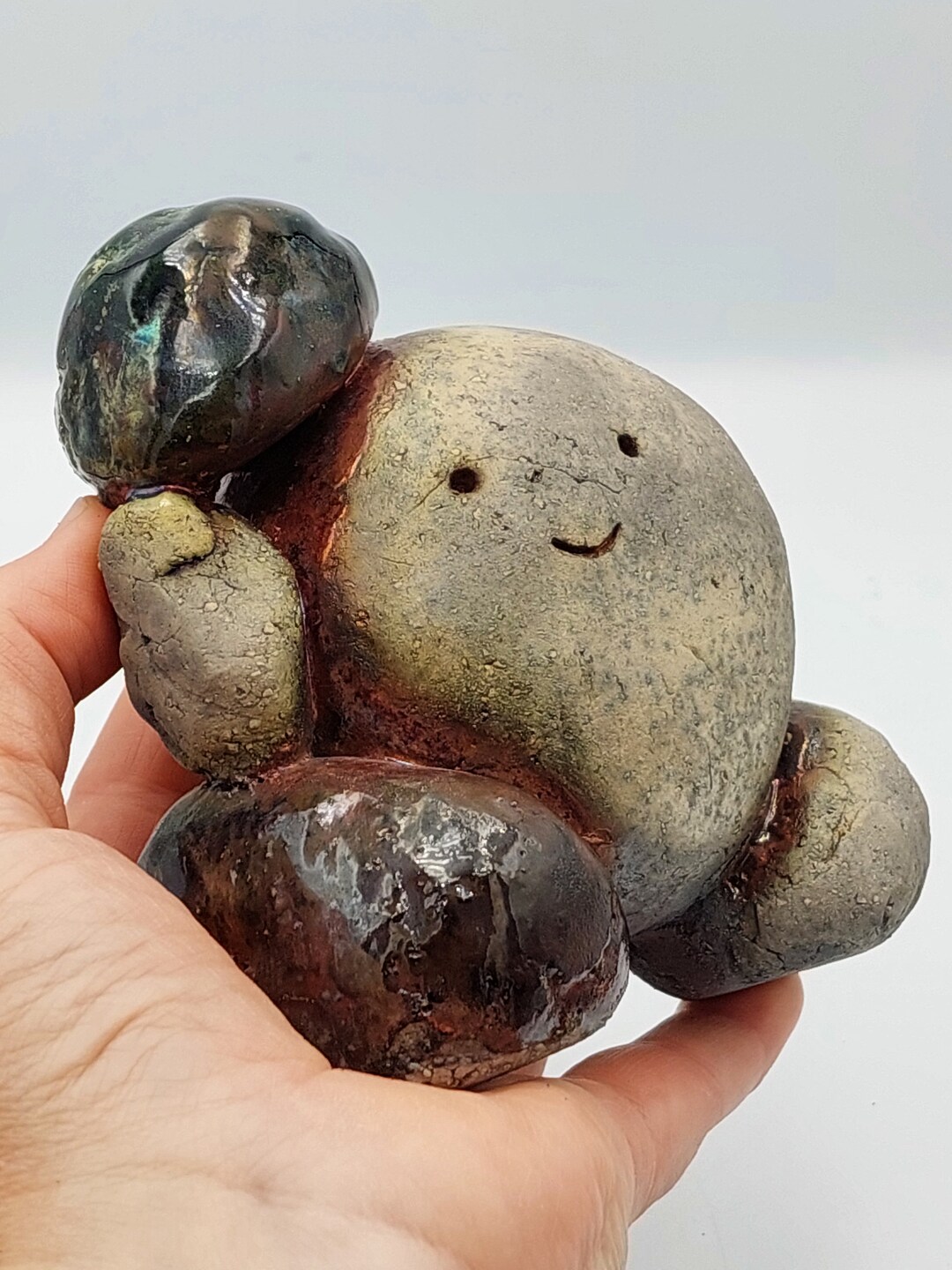 Small Raku Ceramic Pebbles Figure With Smiling Face Stylized Human ...