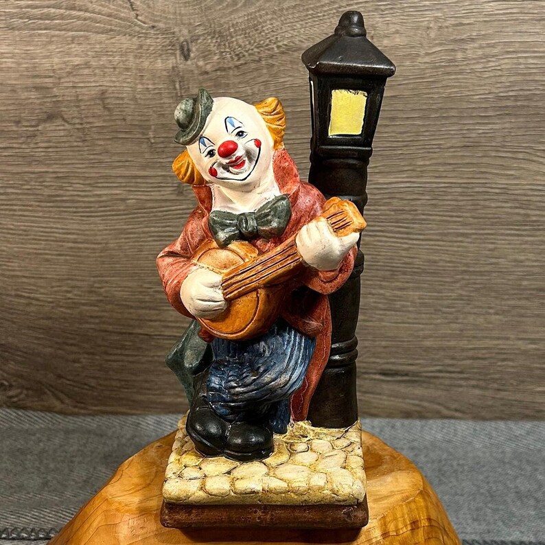 Vintage Happy Smiley Clown Playing a Banjo & Leaning Against an Old ...