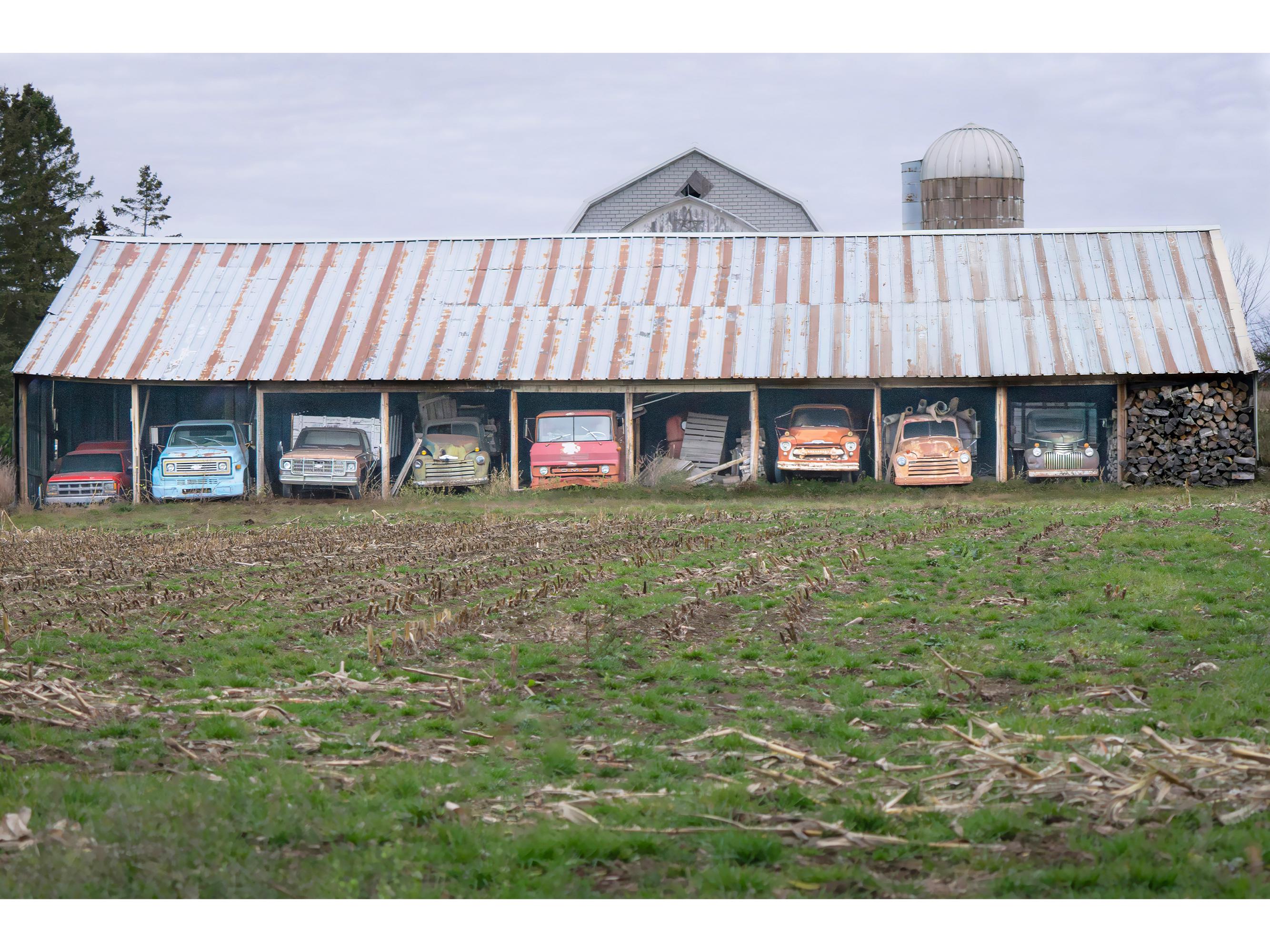 Old Trucks in a Rustic Garage. Vintage Trucks. Antique Trucks. Old ...