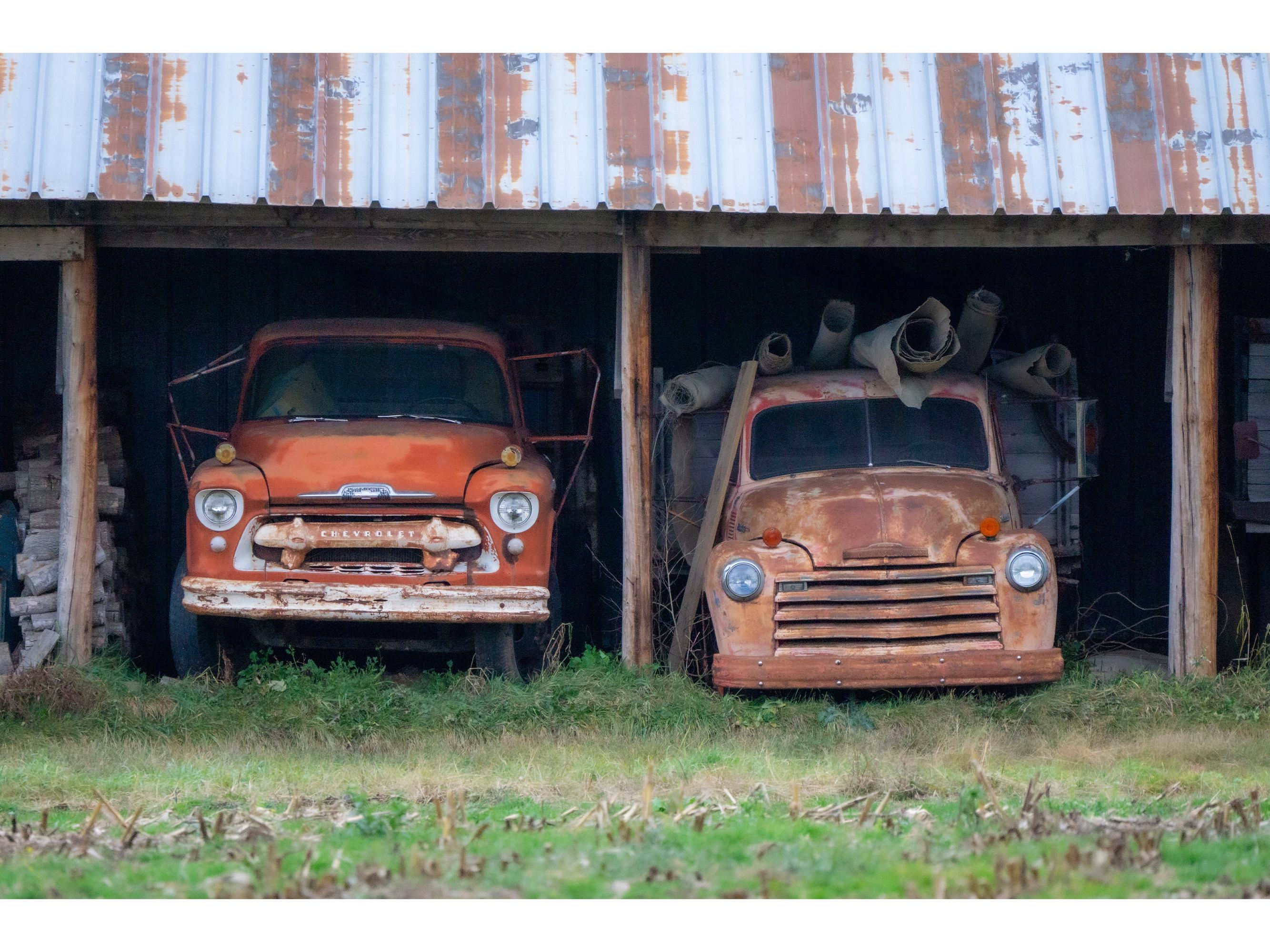 Old Trucks in a Rustic Garage. Vintage Trucks. Antique Trucks. Old ...