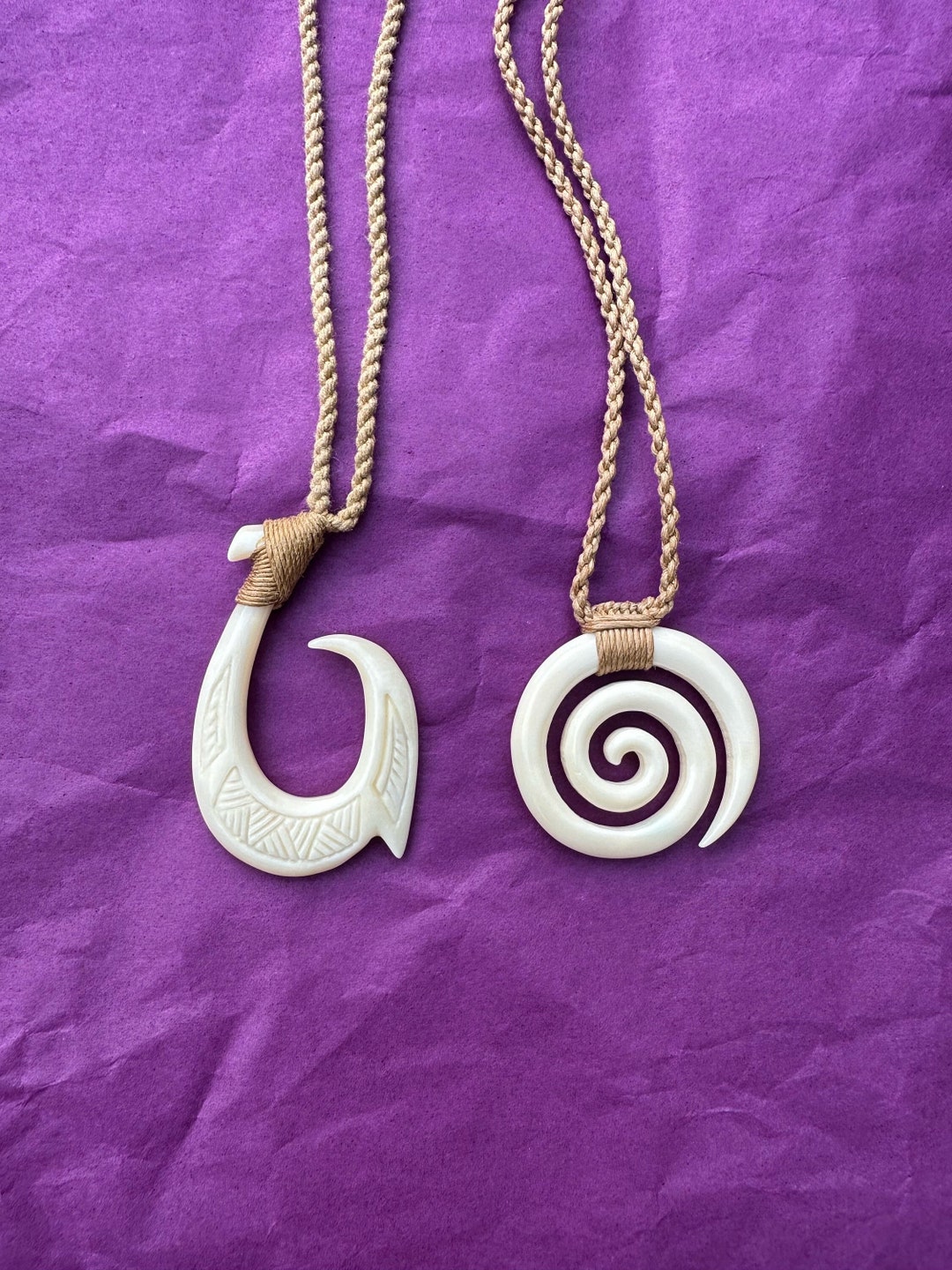 A Maori Engraved Bone Hei Matau Fish Hook Pendant Necklace and A Maori ...