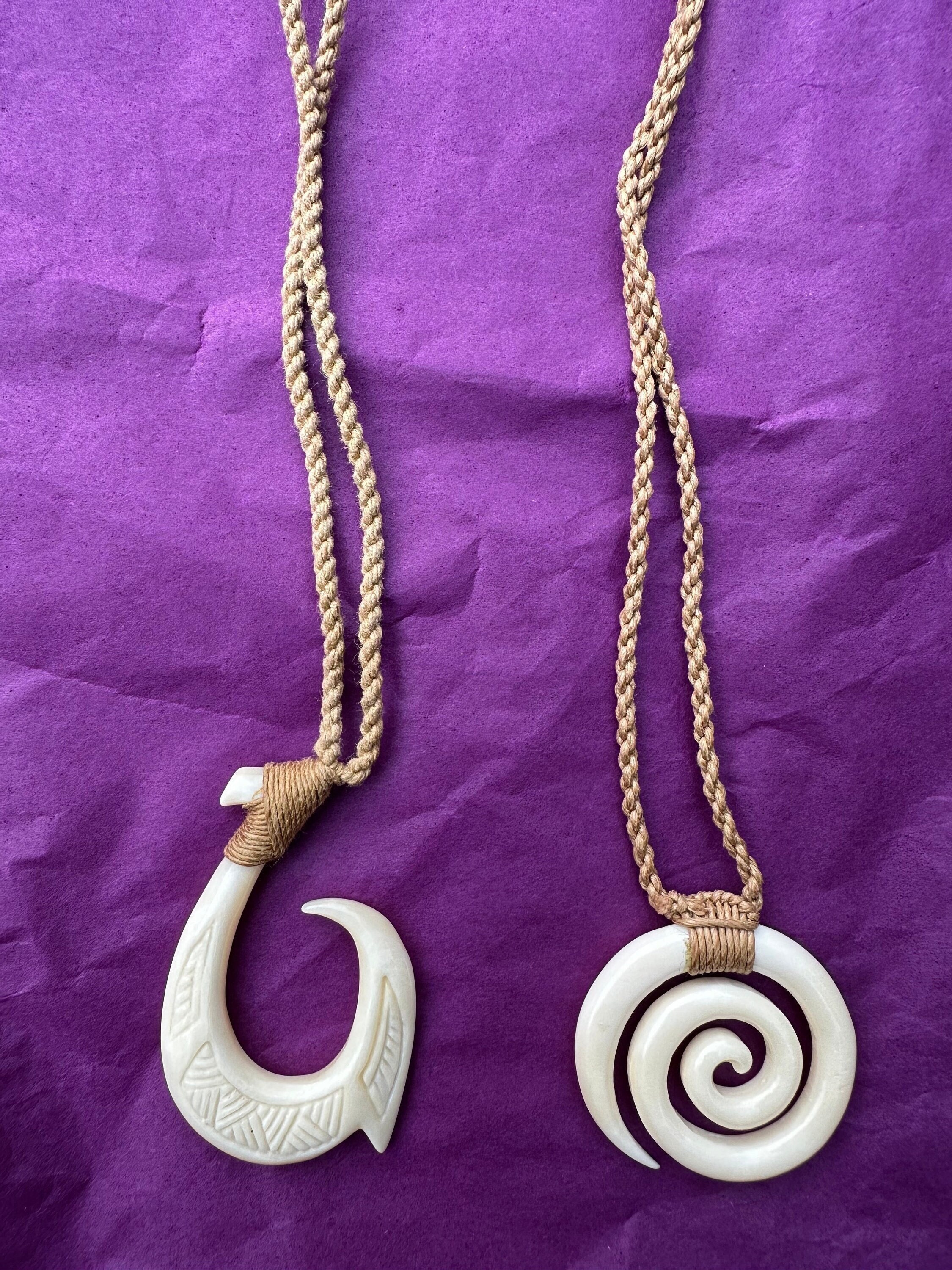 A Maori Engraved Bone Hei Matau Fish Hook Pendant Necklace and A Maori ...