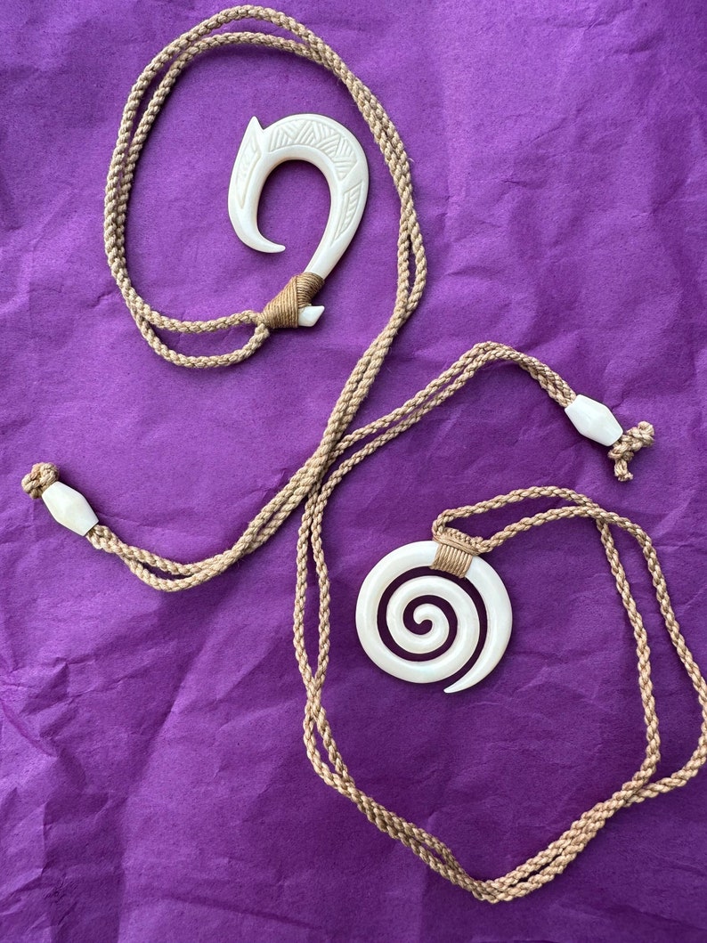 A Maori Engraved Bone Hei Matau Fish Hook Pendant Necklace and A Maori ...