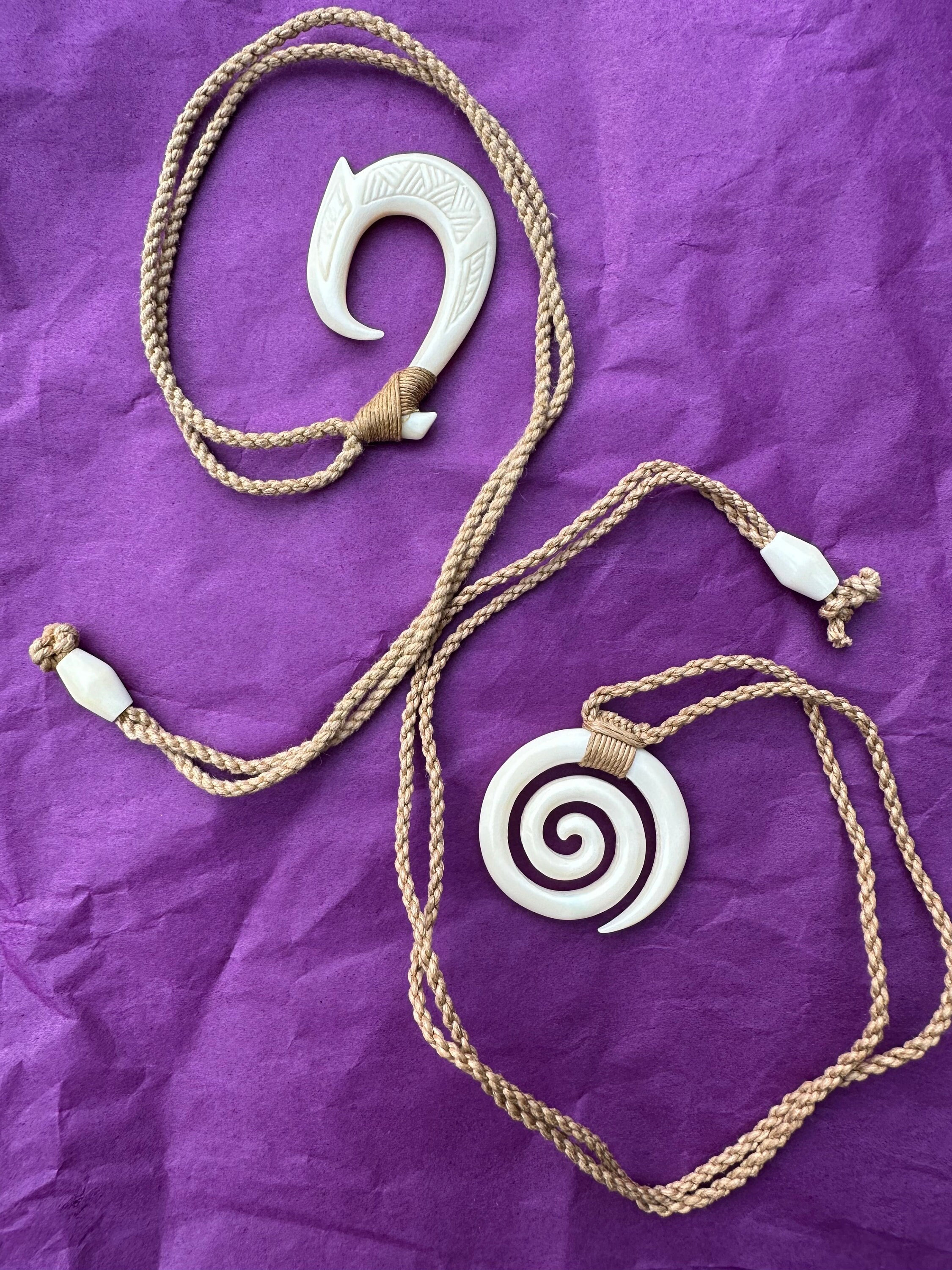 A Maori Engraved Bone Hei Matau Fish Hook Pendant Necklace and A Maori ...