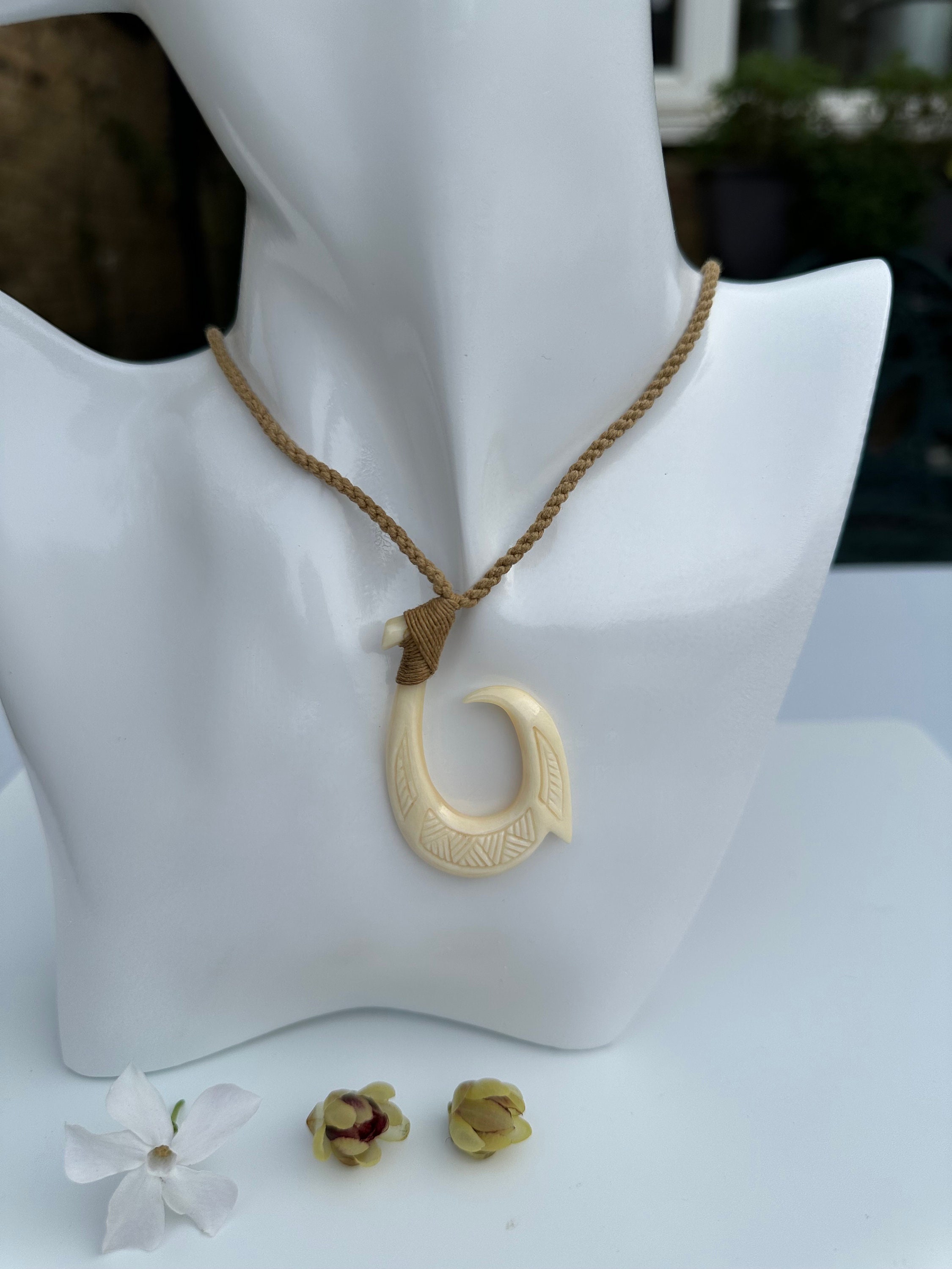 A Maori Engraved Bone Hei Matau Fish Hook Pendant Necklace and A Maori ...