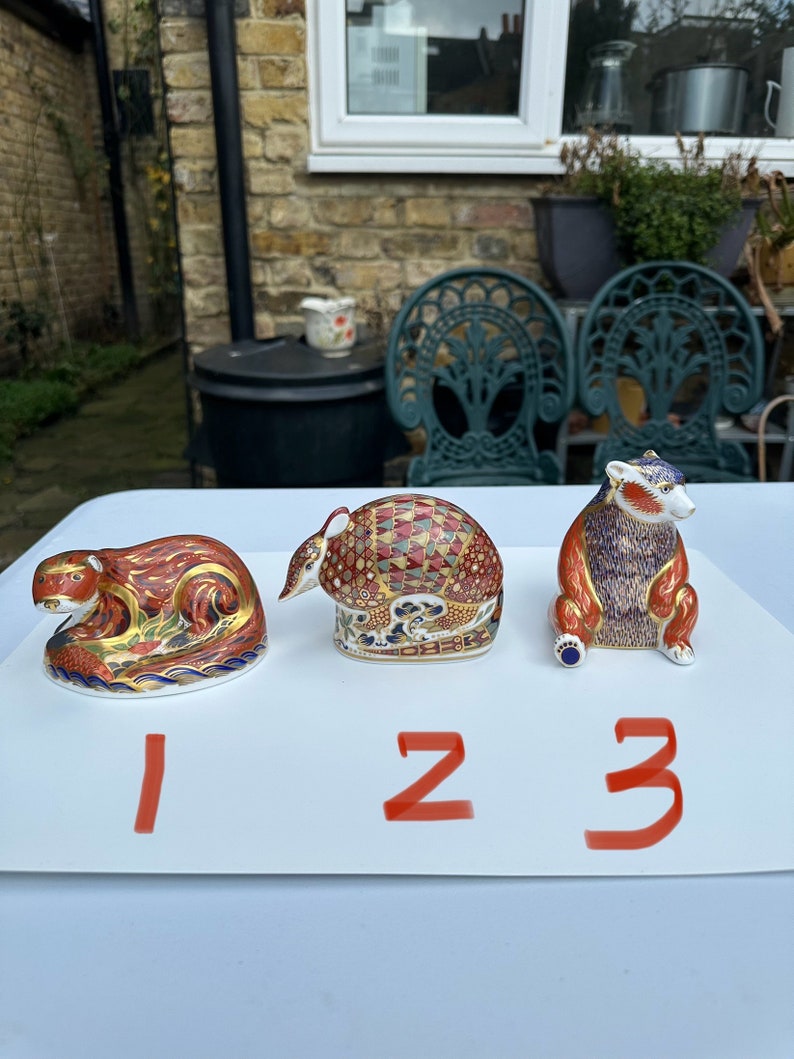 A Group of Royal Crown Derby Paperweights of an Otter, an Armadillo and ...