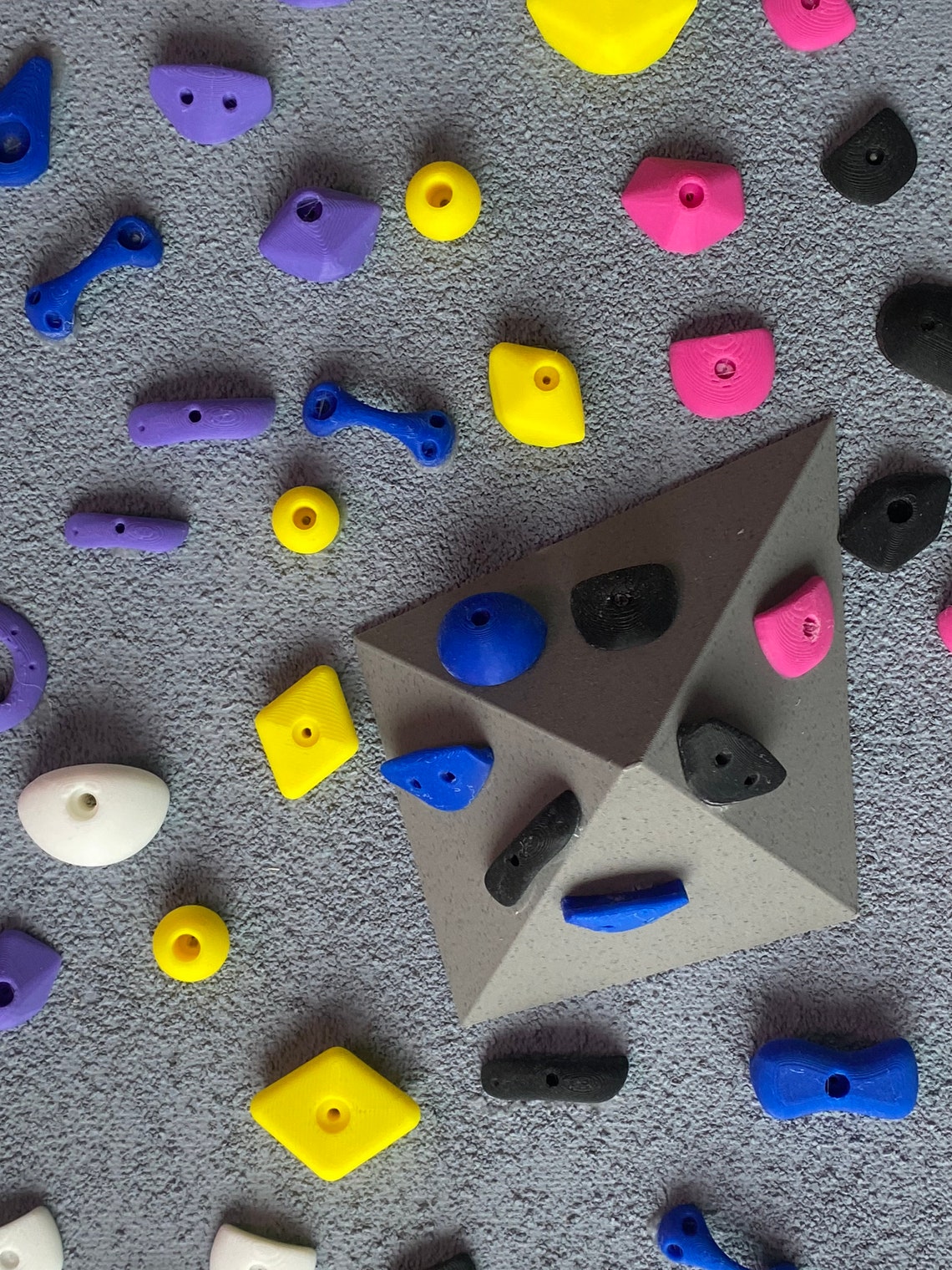 Mini Rock Wall: Various Color 3D Printed Rocks on a Textured Grey Wall ...