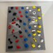 Mini Rock Climbing Wall: Rainbow Colored Rocks on a Small Climbing Wall ...