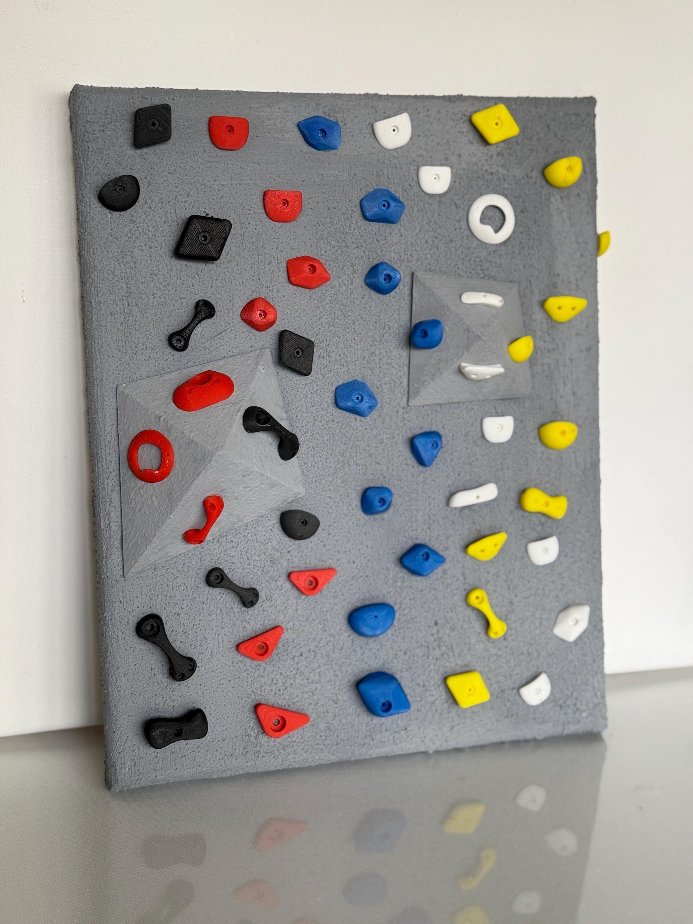 Mini Rock Climbing Wall: Rainbow Colored Rocks on a Small Climbing Wall ...