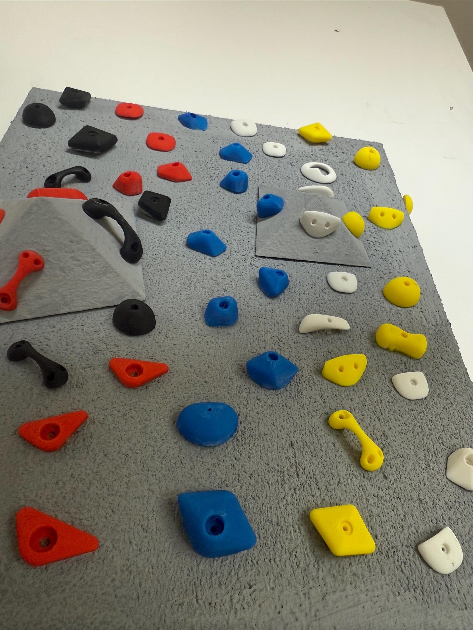 Mini Rock Climbing Wall: Rainbow Colored Rocks on a Small Climbing Wall ...