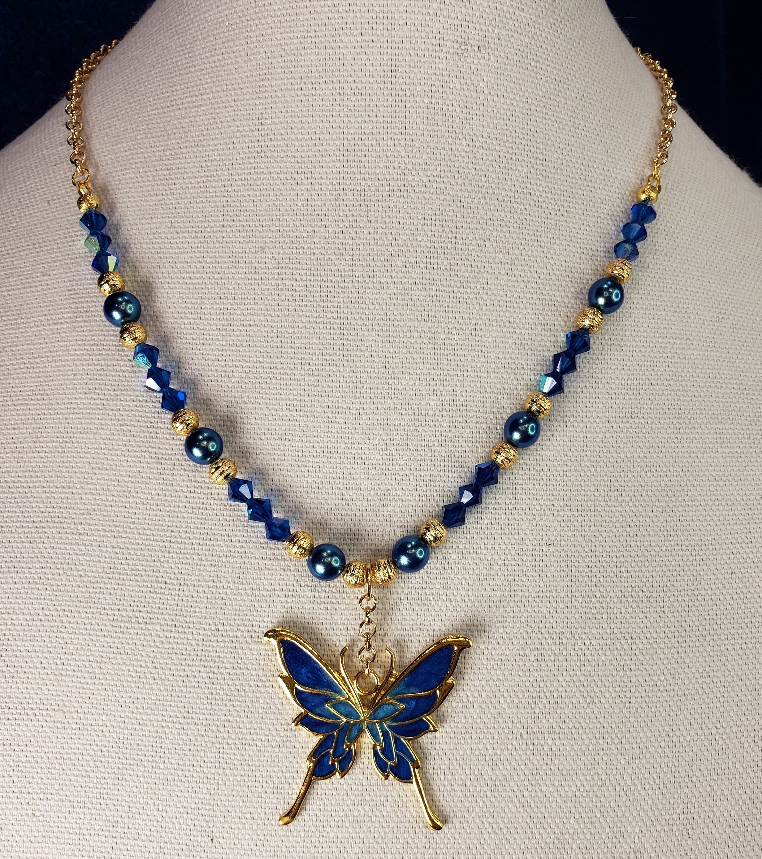 Elegant Blue and Gold Butterfly Pendant Flutters Below the Blue Beads ...