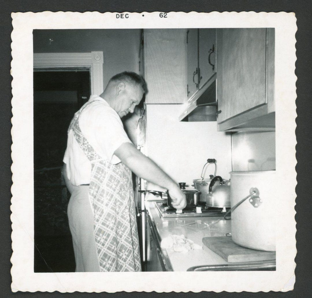 Apron Wearing Man Cooking at Cramped Kitchen Stove Mid Century Interior ...
