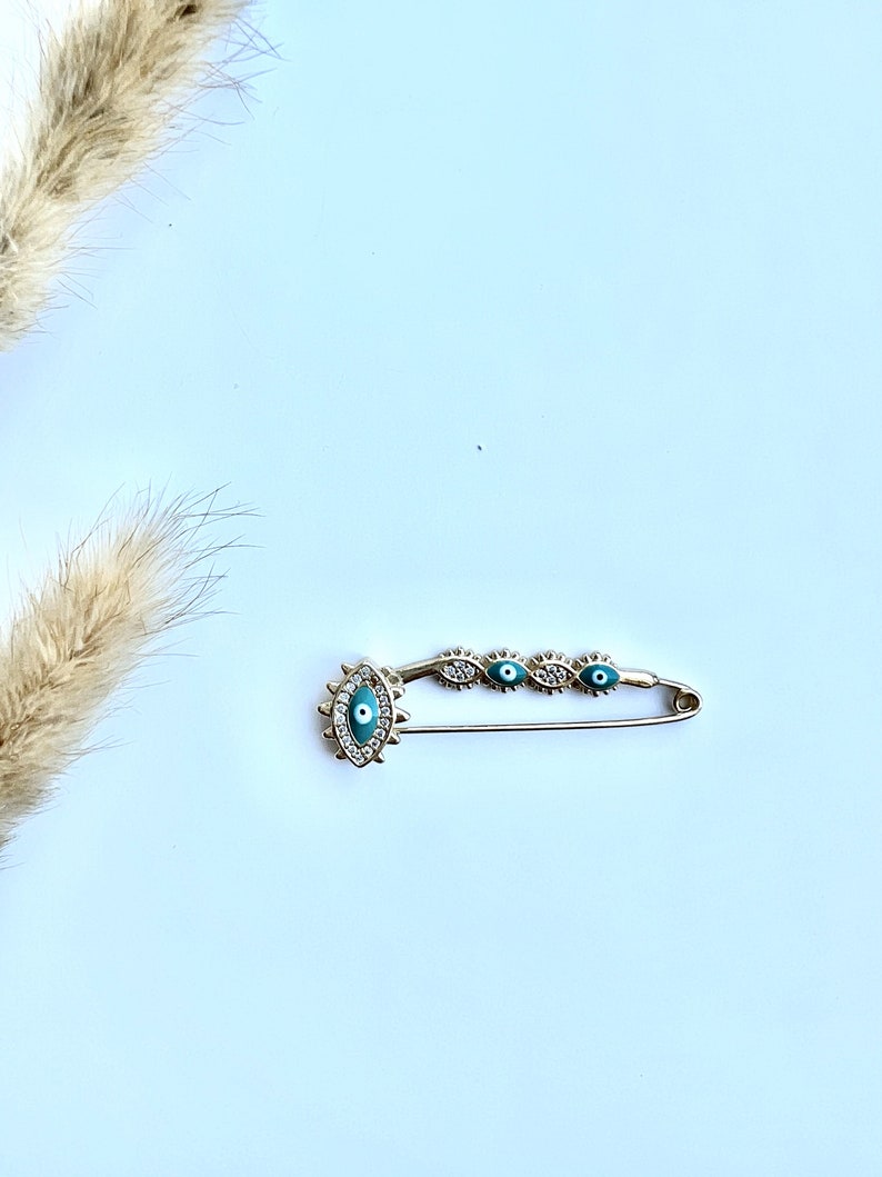 The Evil Eye Baby Pin is a Unique Accessory That Adds a Touch of ...