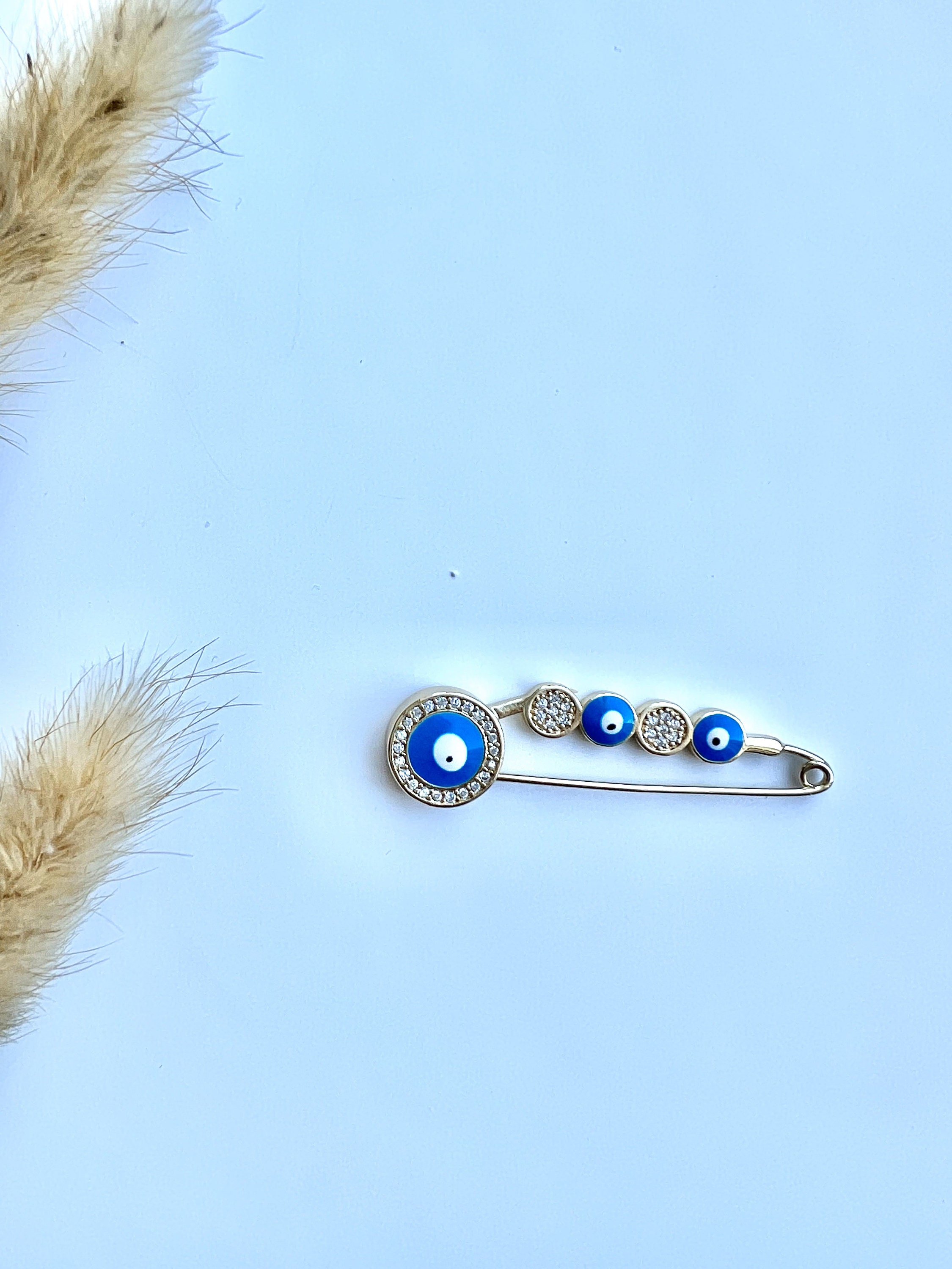 The Evil Eye Baby Pin is a Unique Accessory That Adds a Touch of ...