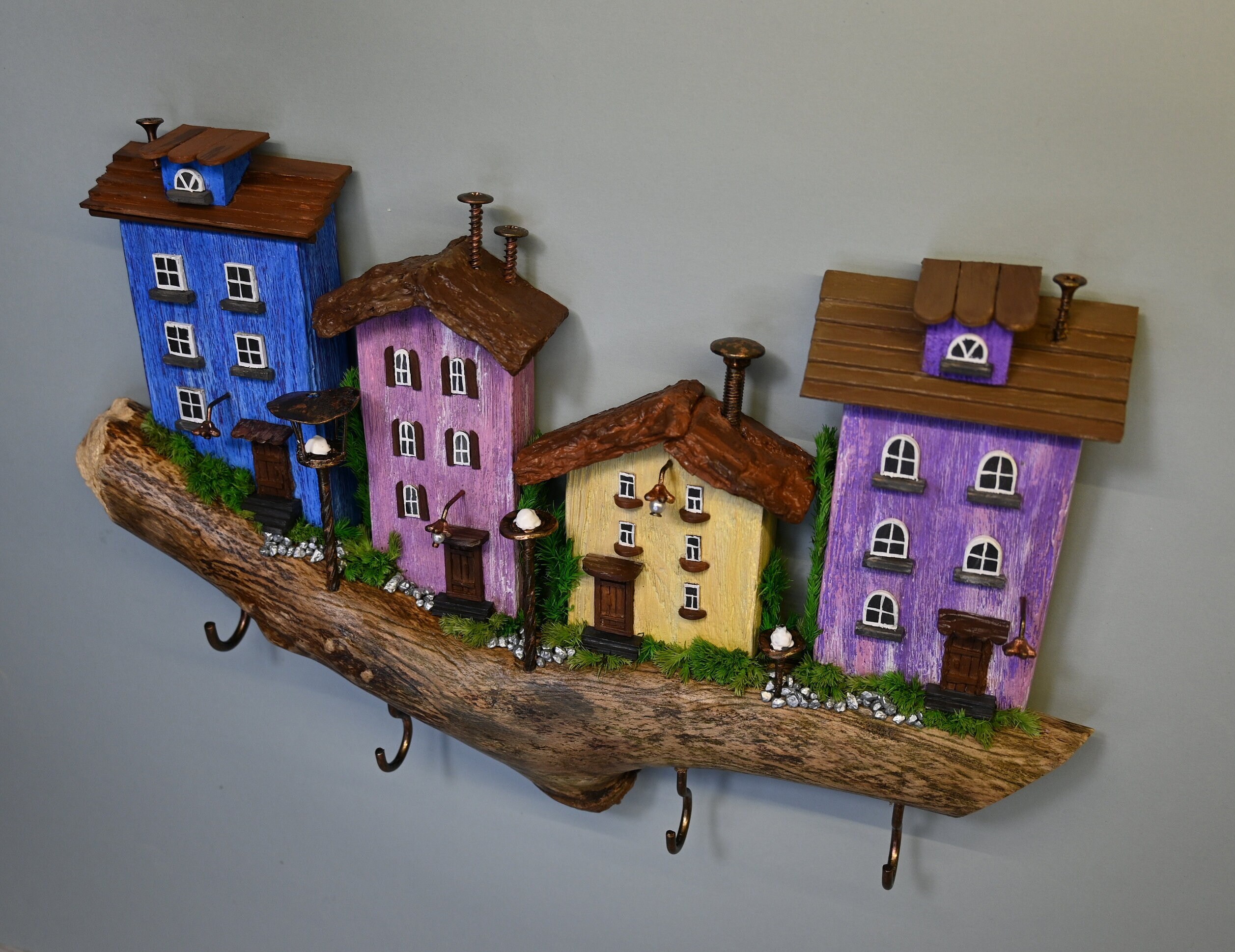 Wooden Key Holder With Colorful Houses and Green Plants on a Wild ...