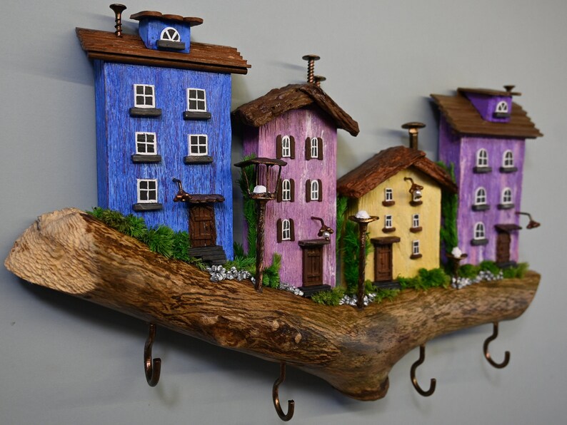 Wooden Key Holder With Colorful Houses and Green Plants on a Wild ...