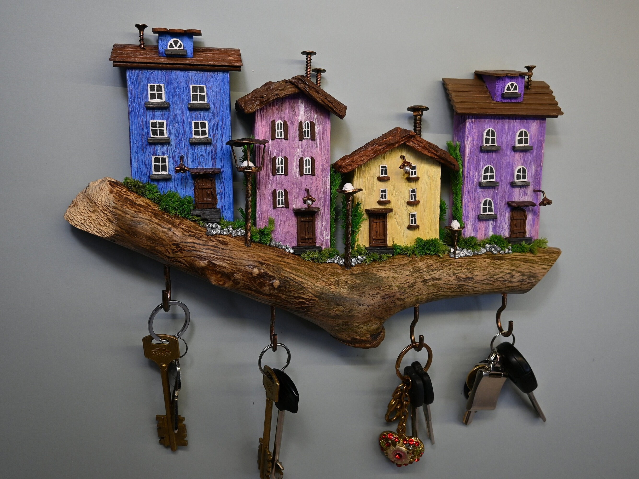 Wooden Key Holder With Colorful Houses and Green Plants on a Wild ...