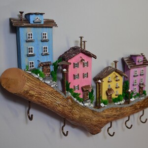 Wooden Key Holder With Colorful Houses and Green Plants on a Wild ...