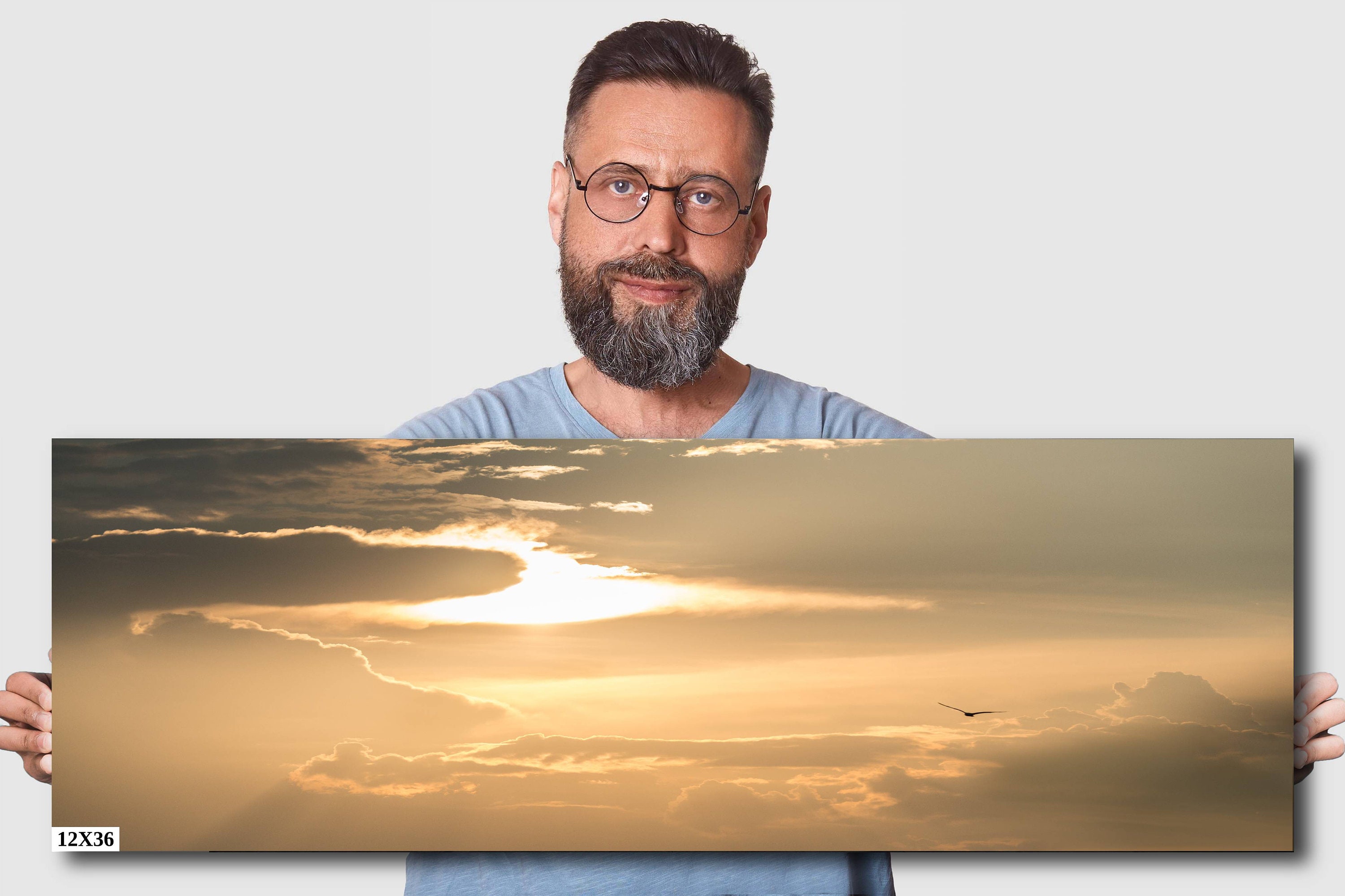 Photograph of Lone Bird Flying Through Golden Cloudscape at Sunset Over ...