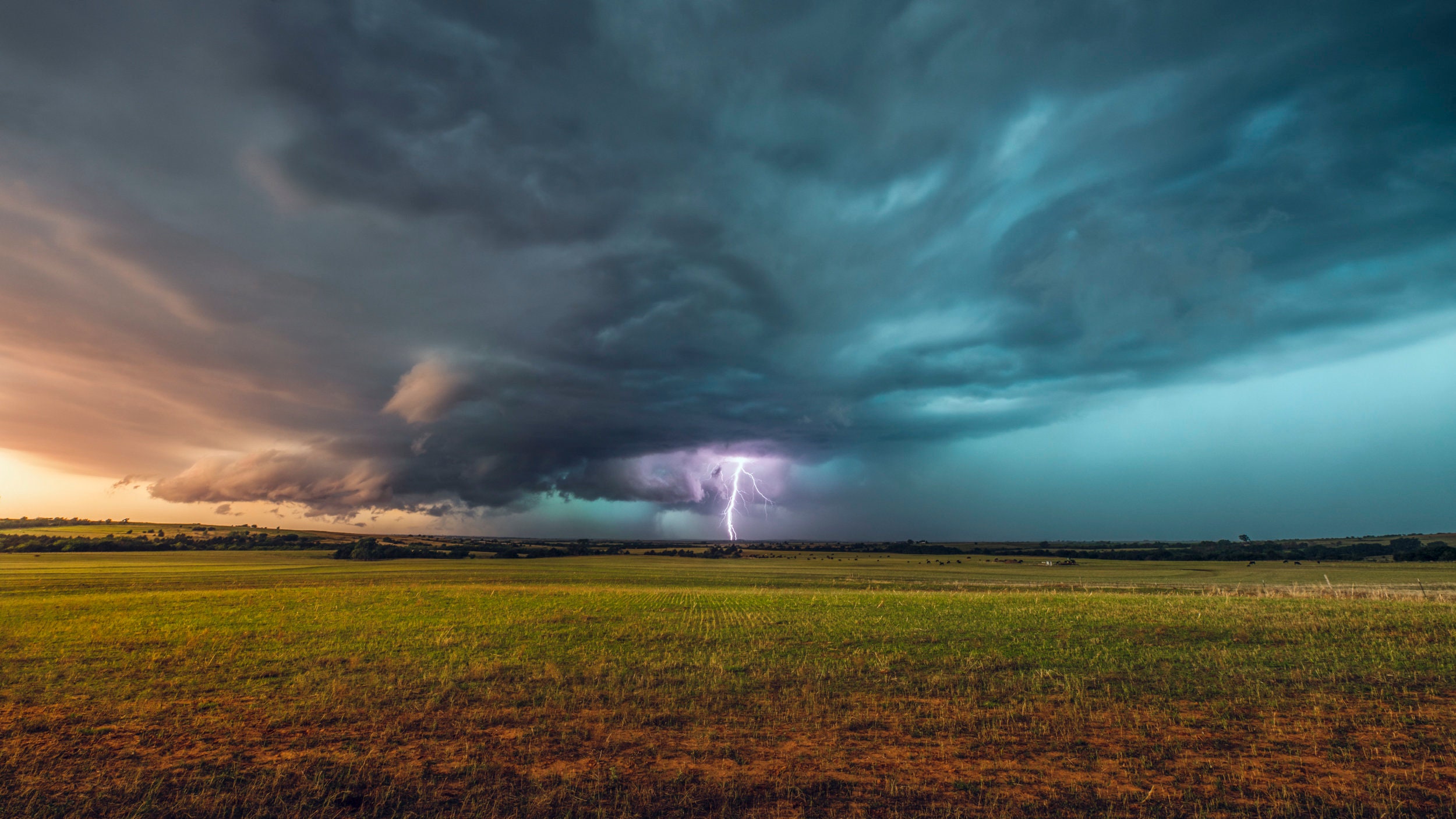 An Approaching Supercell Storm Creates Intense Colors as a Lightning ...