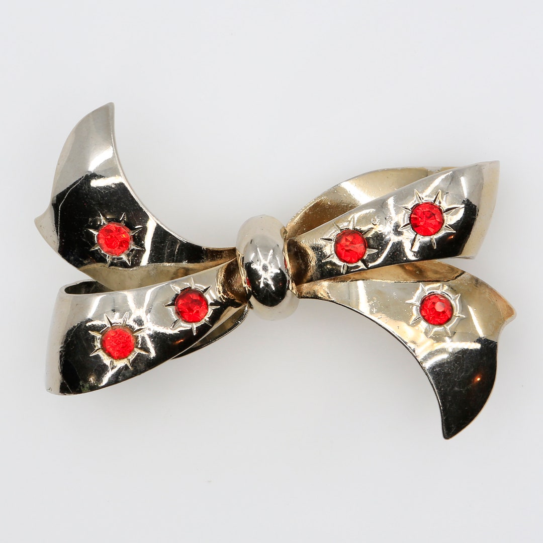 Vintage Natalie Art Moderne broche de arco de tono plateado con ...