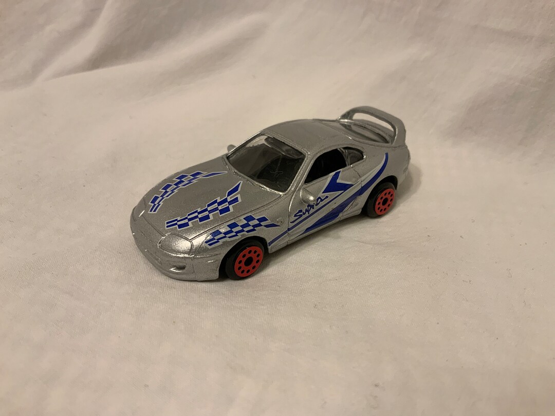 Motormax Diecast Toyota Supra With Red Rims and Blue and White Racing ...