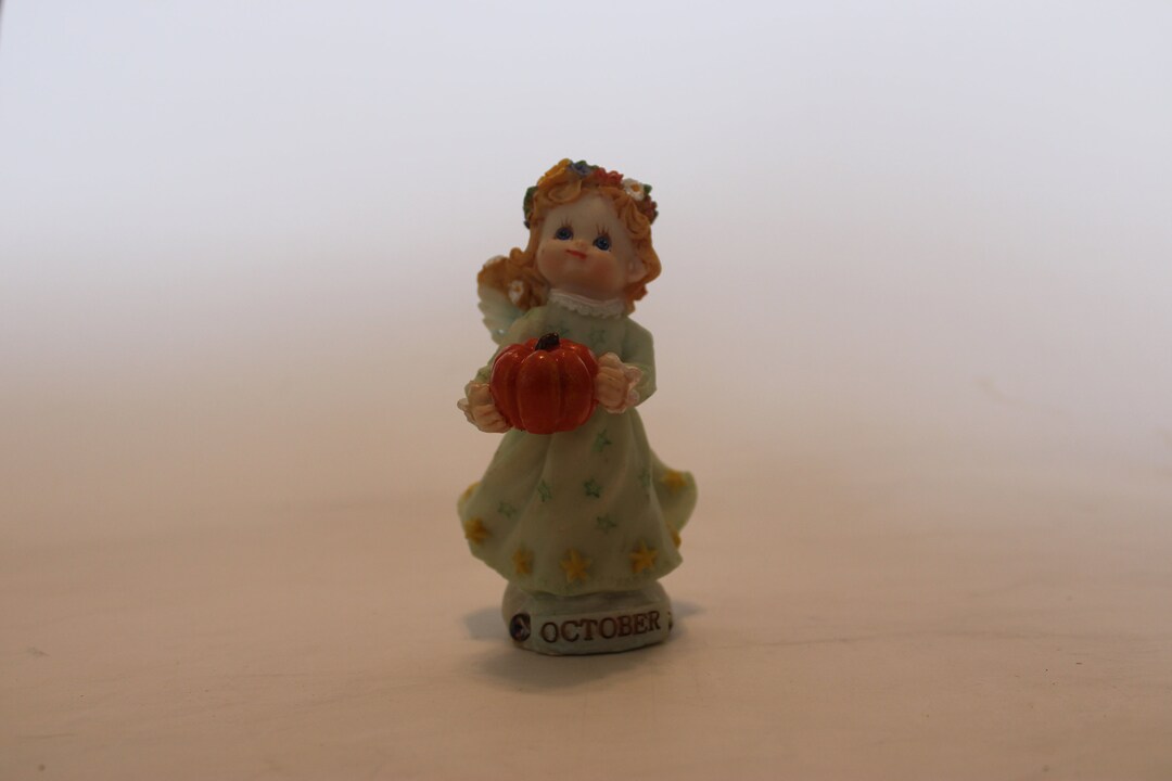 October Birthday Angel With Flower Crown and Holding a Bright Orange ...