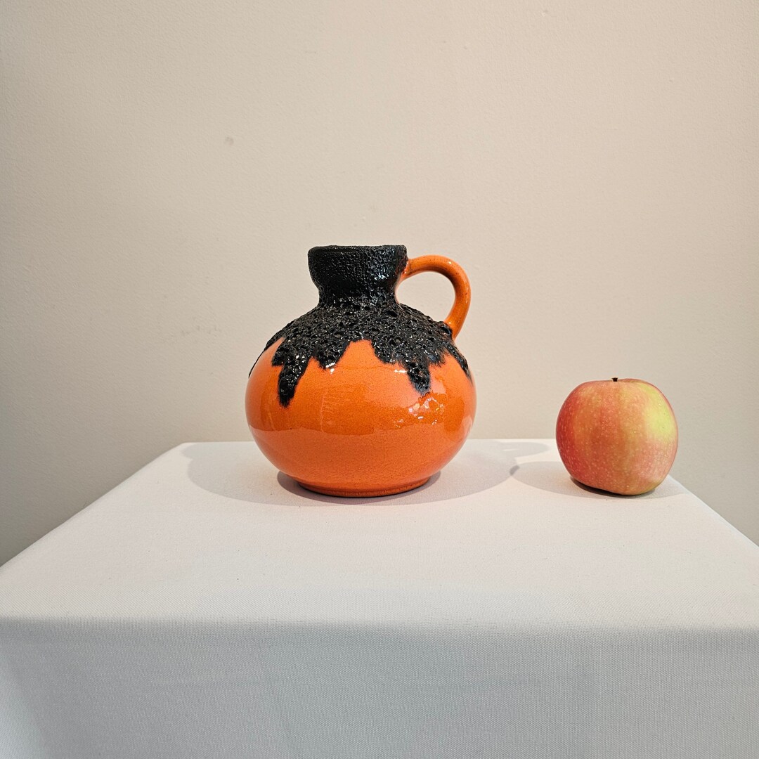 A West German Fat Lava Vase Made by Roth. the Vase is Orange With Black ...