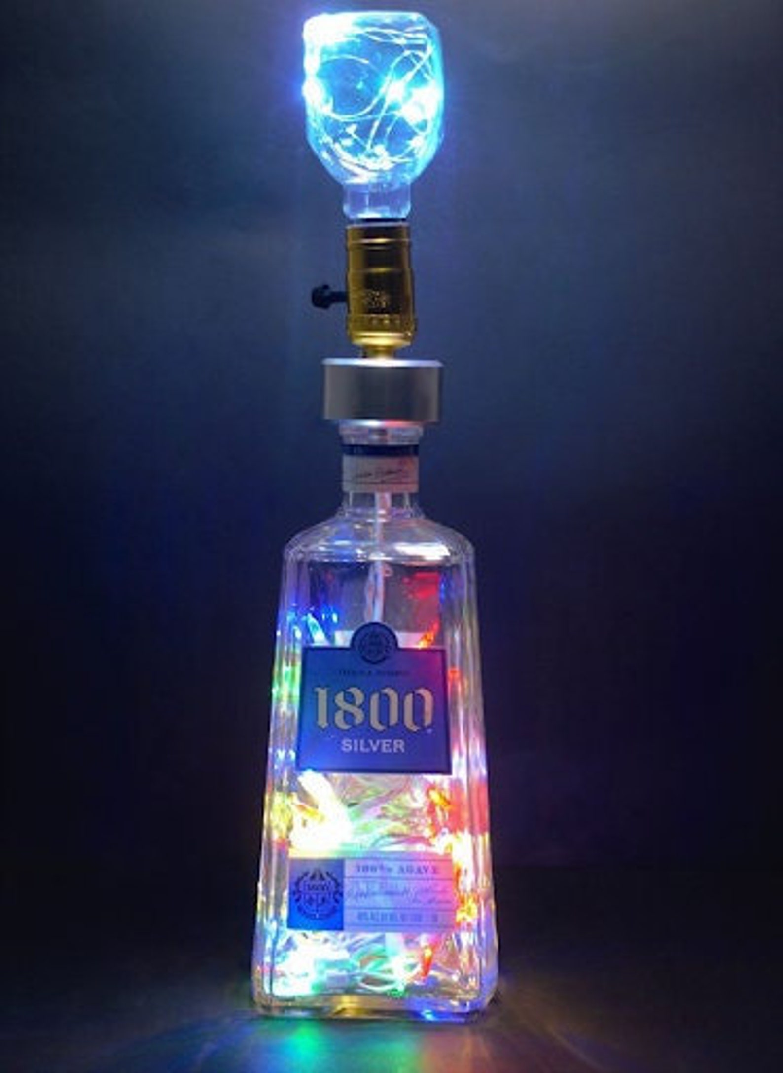 1800 Tequila 1.75-liter Upcycled Lamp. Multicolored String Lights Fill ...