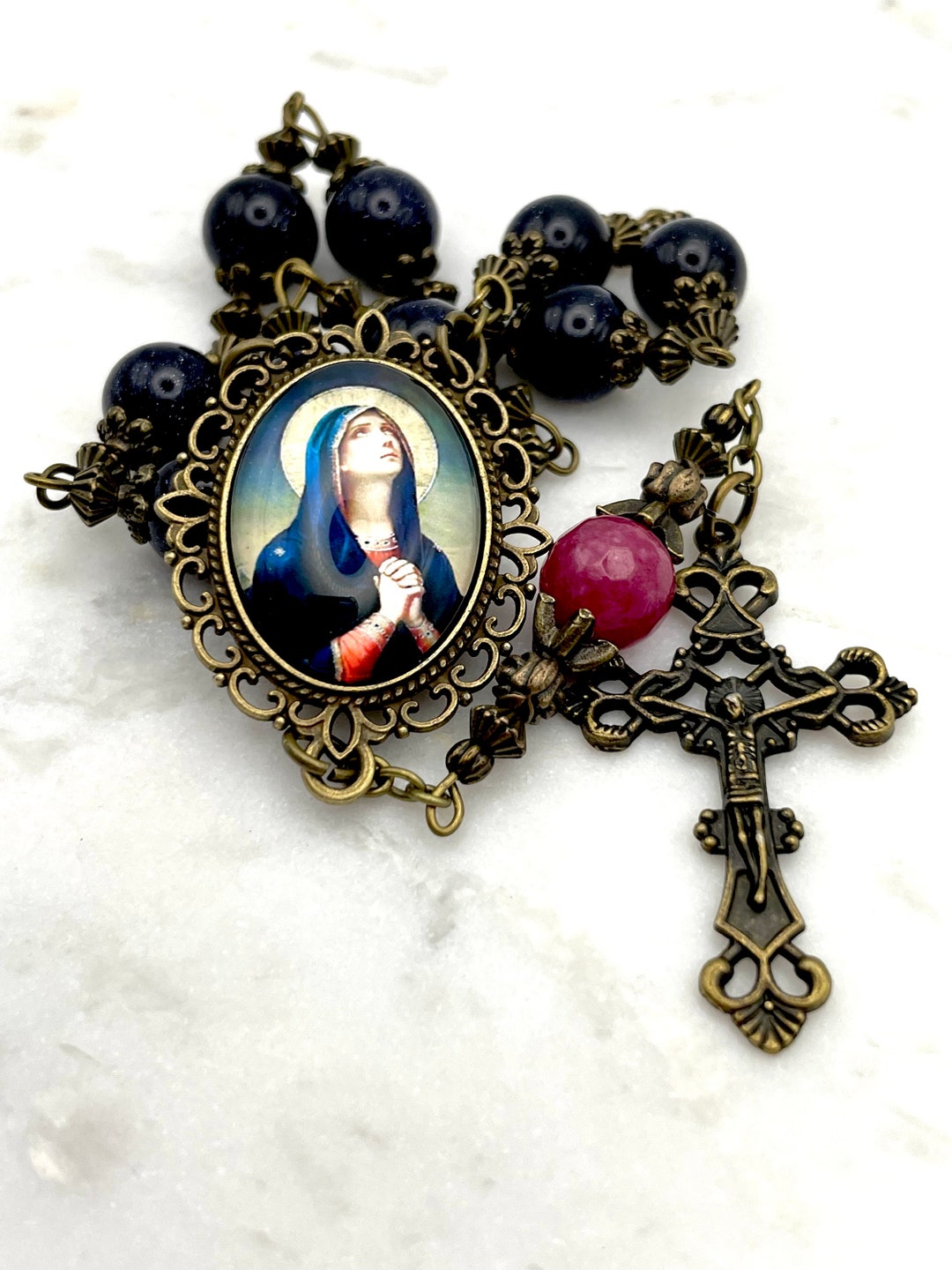 Our Lady of 7 Sorrows Marian, AAA Ruby + Blue Sandstone Gemstone Tenner ...