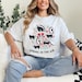 Spring in the Air Cotton Tee | Spring Skunks and Flowers Comfy T-shirt ...