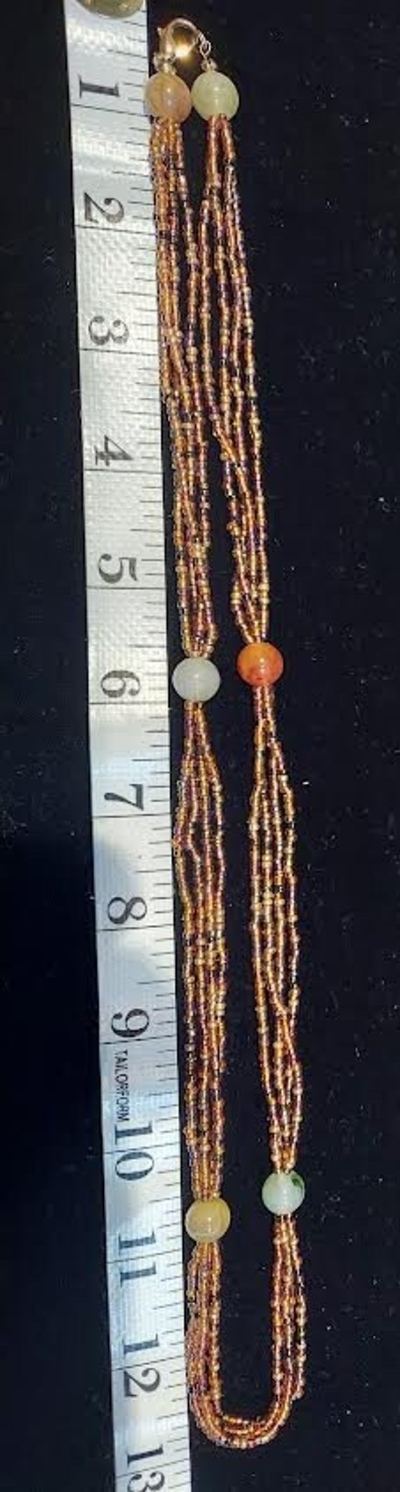 4-strand seed bead necklace has some beads coated wit… - Gem