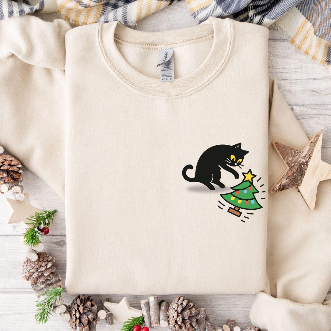 Funny Cat Knocking Christmas Tree Sweatshirt: Black Cat Holiday ...