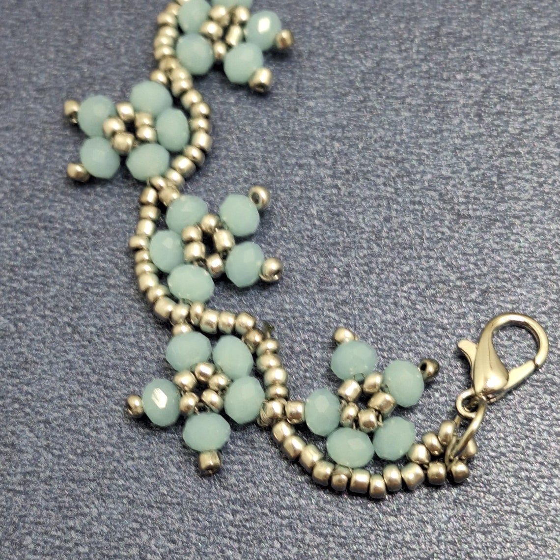 Beautiful Handmade Bracelet Features a Stunning Spiral Design With Cyan ...