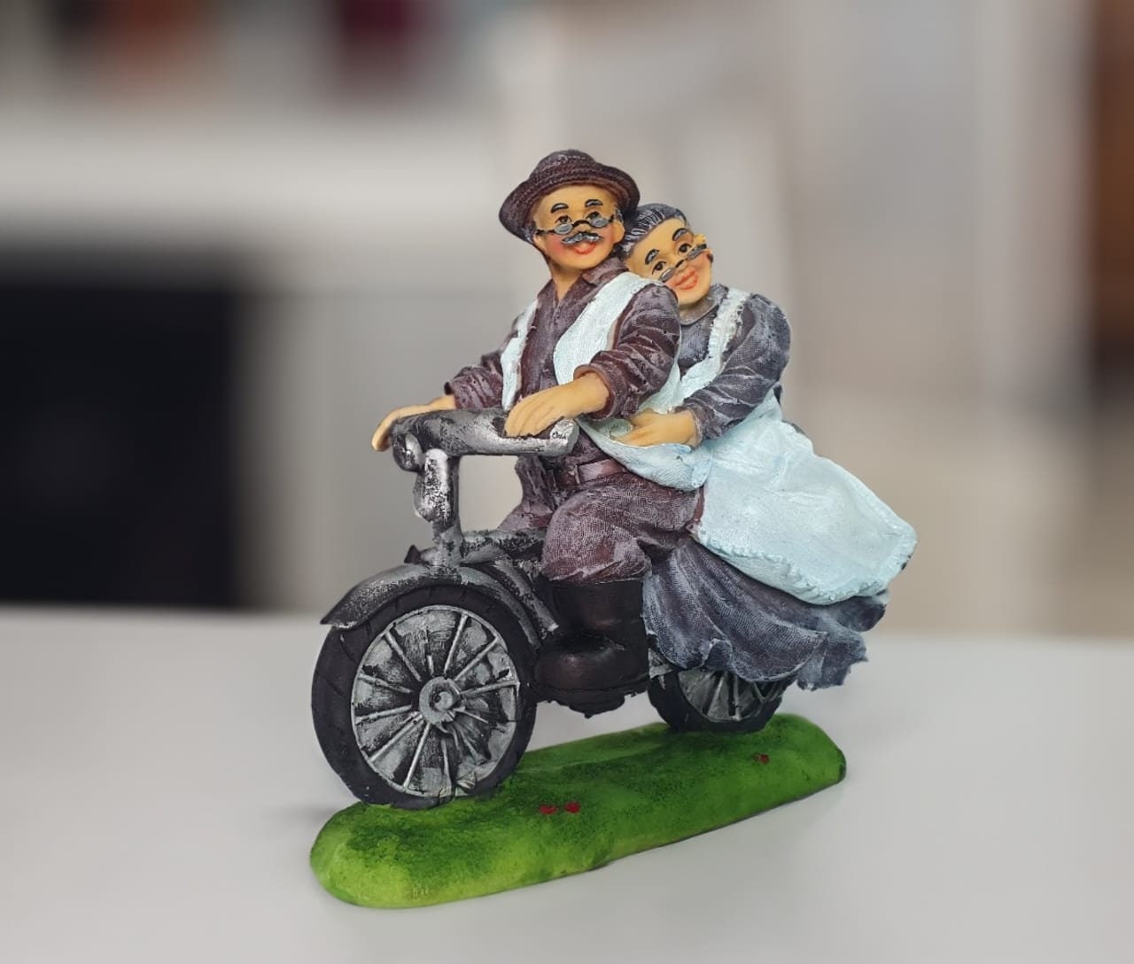 TCG 21cm Dada Dadi Statue Riding Bike Comes in Multi Colour. It Shows ...