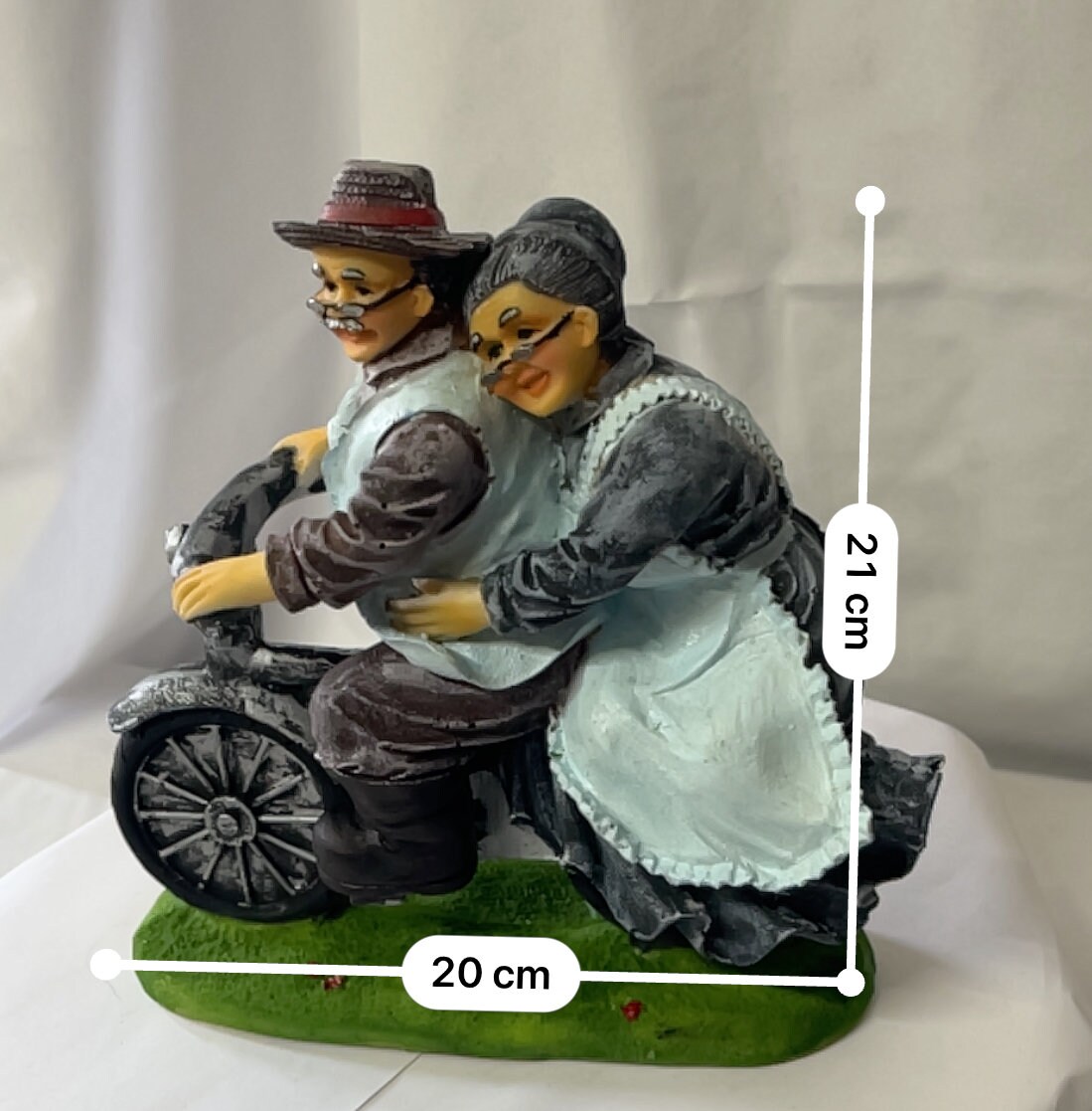 TCG 21cm Dada Dadi Statue Riding Bike Comes in Multi Colour. It Shows ...