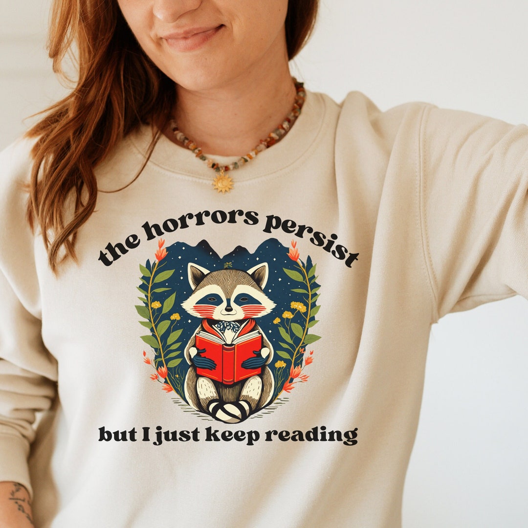 The Horrors Persist Raccoon Meme Sweatshirt, Raccoon Reading Sweatshirt ...