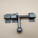A Door Latch, Handcrafted in a Rustic Style, Ensures Reliable and Easy ...