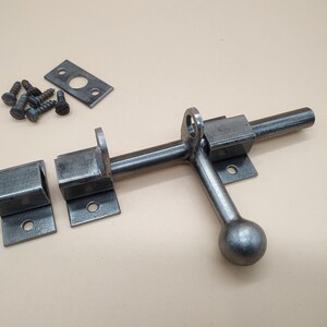 A Door Latch, Handcrafted in a Rustic Style, Ensures Reliable and Easy ...