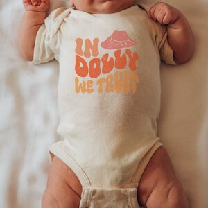 In Dolly We Trust Parton Baby Onesie® - Country, Western Baby Onesie ...