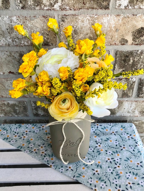 Fake yellow flowers in vase store