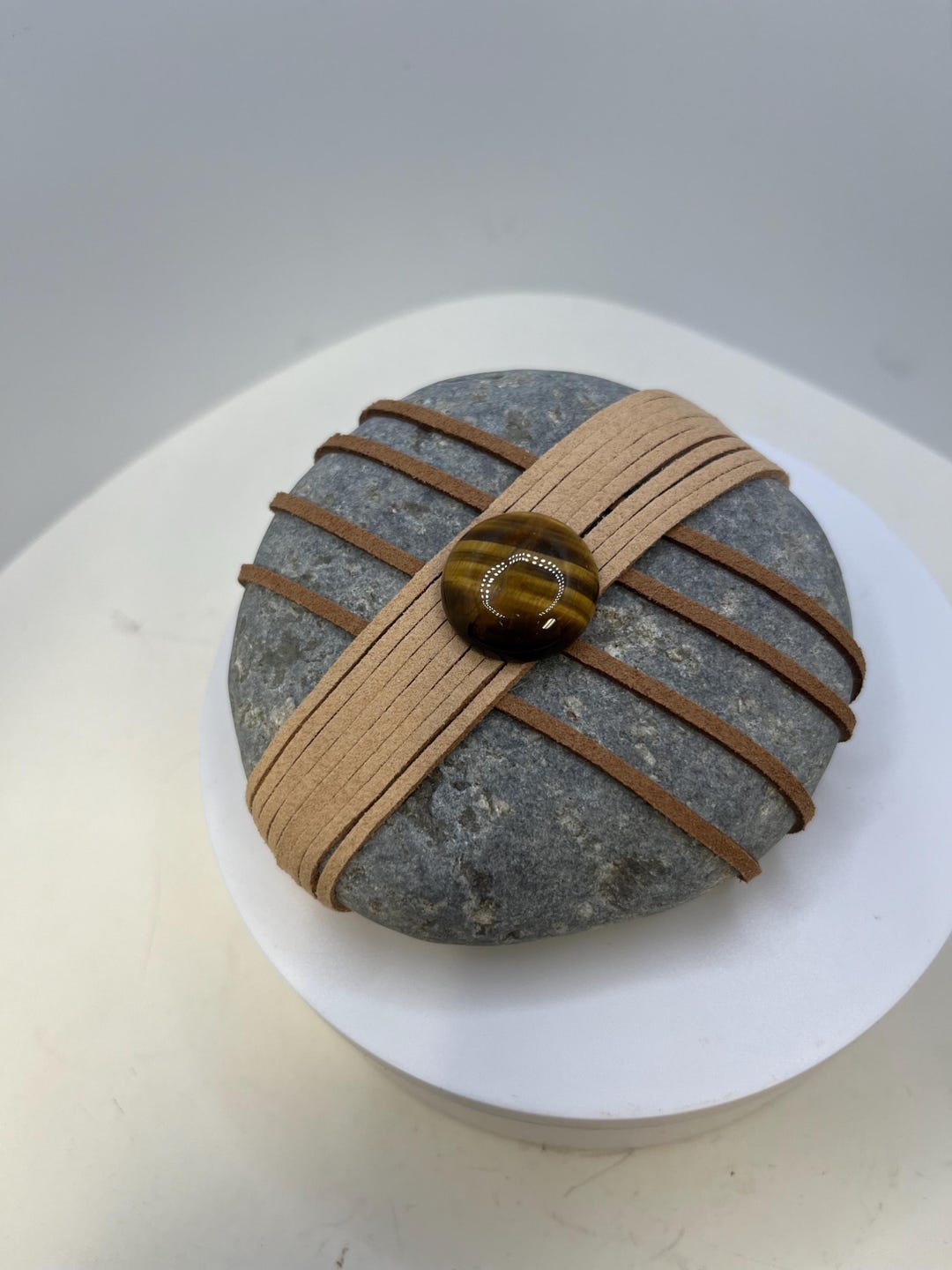Smooth Natural Oval Rock Wrapped in Beige and Tan Leathers, With a ...