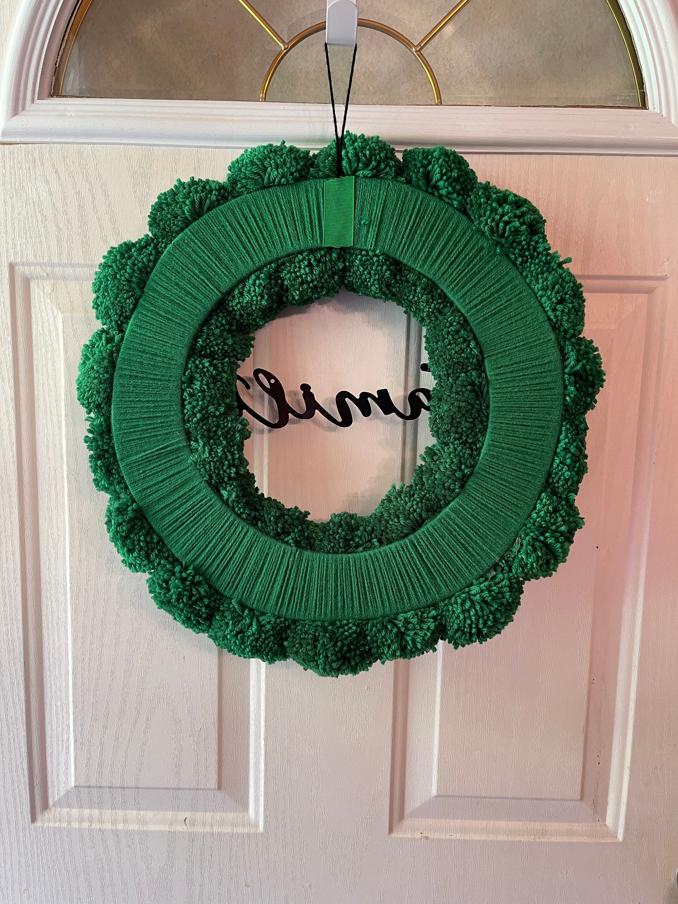 The Word Family is in the Middle of This Homemade Pompom Wreath Its ...