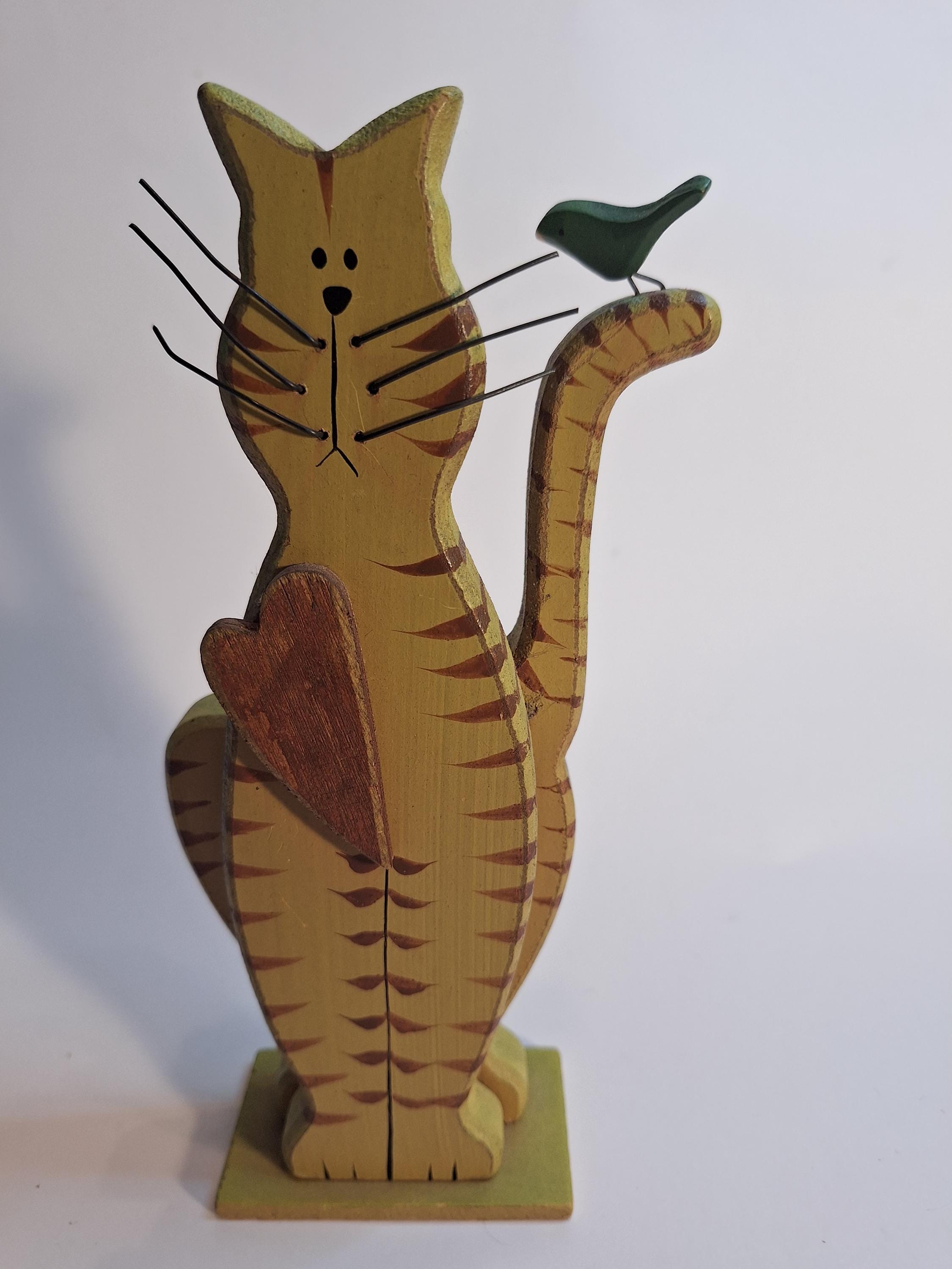 Wooden Olive Green Tabby Cat With Brown Stripes. Black Crow on His ...