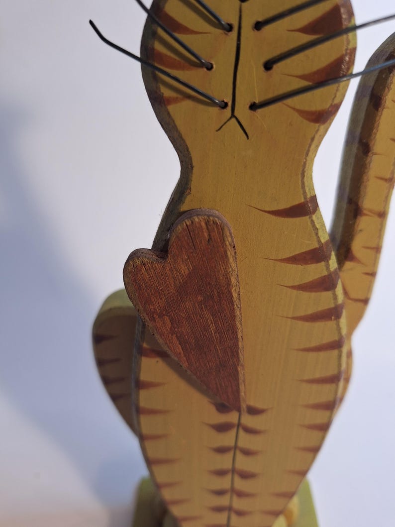 Wooden Olive Green Tabby Cat With Brown Stripes. Black Crow on His ...