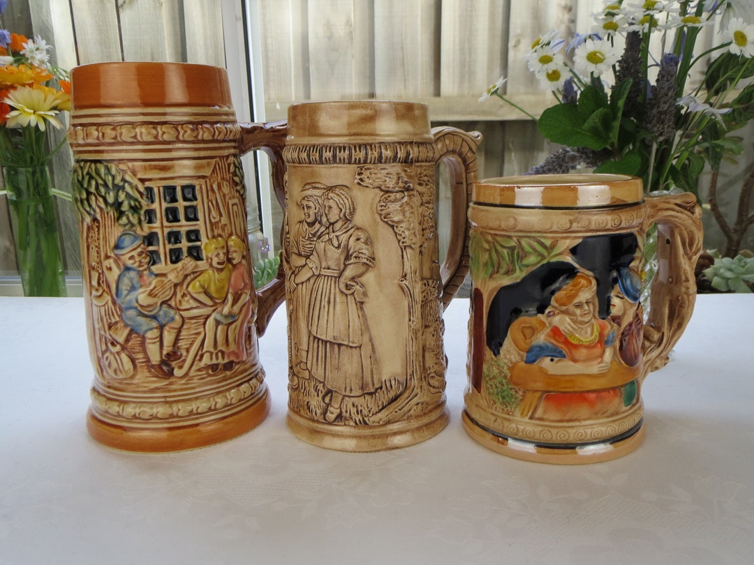 Various Handmade Ceramic Beer Steins With Wrap Around Scenes and Ornate ...